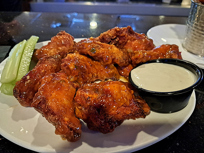 These wings aren't just crispy—they're having a meaningful relationship with that Buffalo sauce. Celery sticks standing by for moral support and cooling relief.