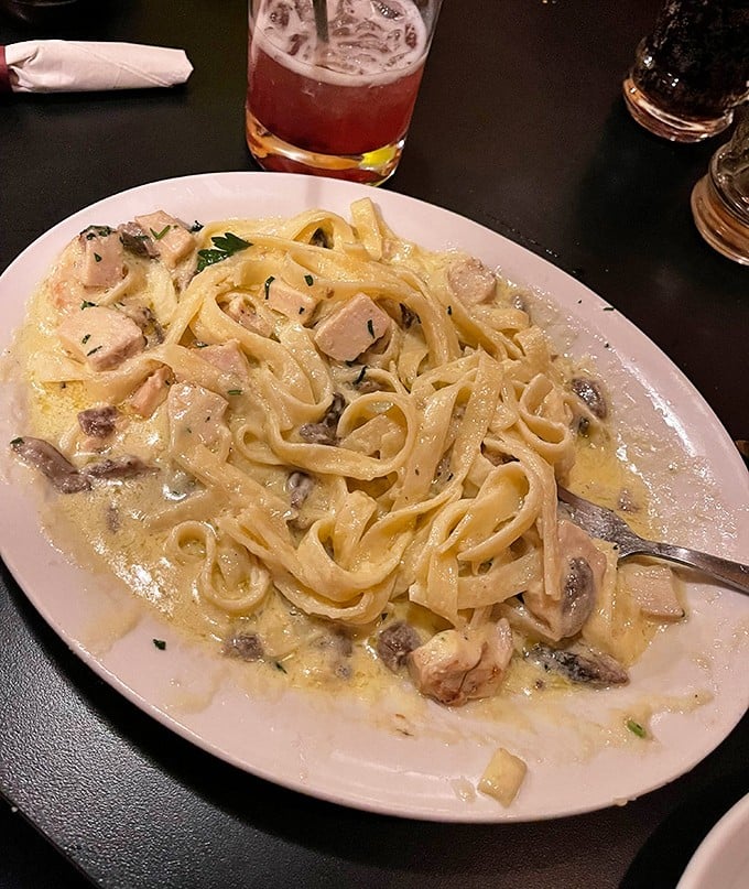 This chicken fettuccine Alfredo isn't just dinner—it's a silky, creamy masterpiece that makes you understand why people willingly drive hours for a single forkful.
