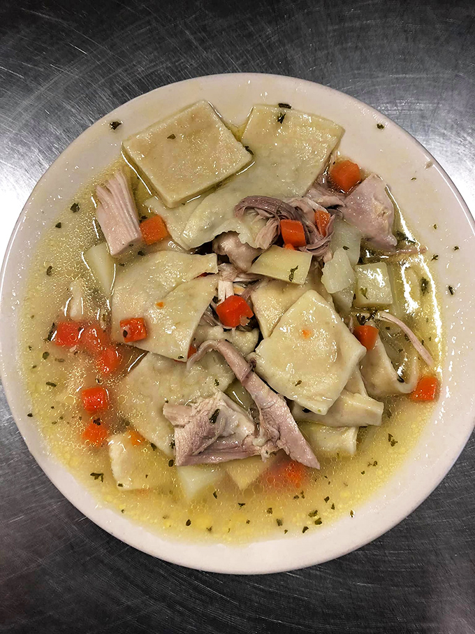 This isn't your grocery store pot pie – square-cut noodles swimming with tender chicken in a broth so comforting it could end family feuds.