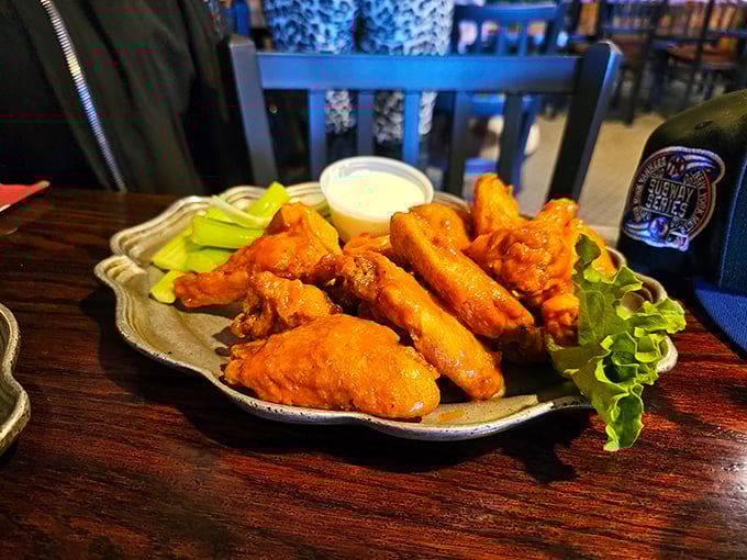 These wings aren't just taking flight—they're soaring to flavor heaven. Crispy, saucy perfection served with the obligatory celery nobody actually eats.