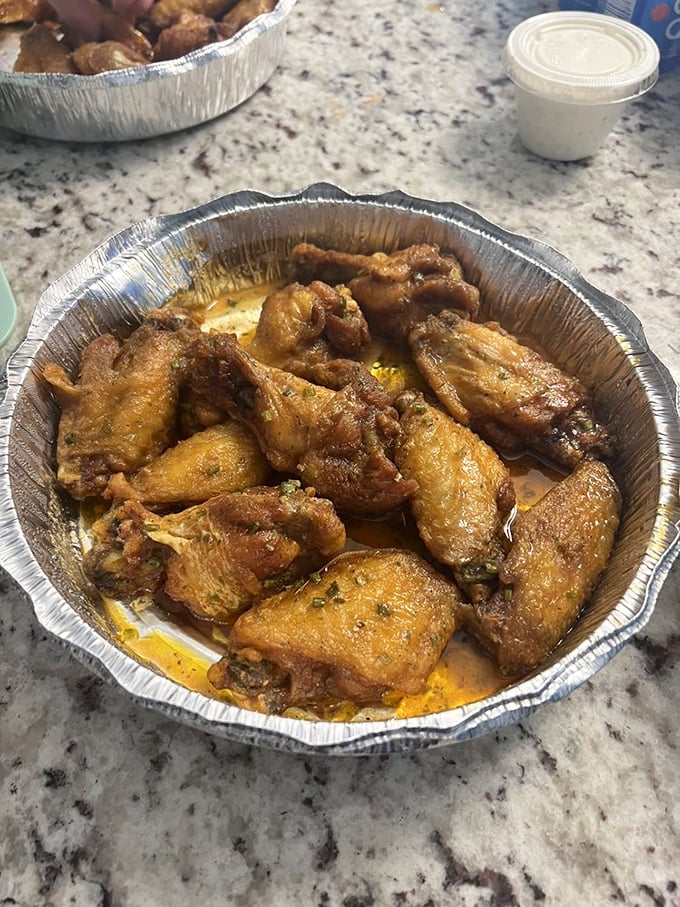 Golden-brown wings glistening with sauce that practically whispers, "Go ahead, lick your fingers. We won't judge." Napkins are merely a suggestion here.