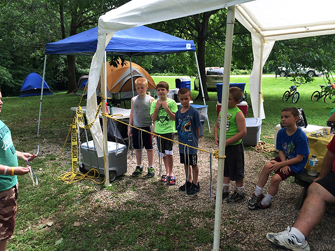 Young adventurers plotting their next expedition—this is how childhood memories are constructed, one tent stake and ghost story at a time.