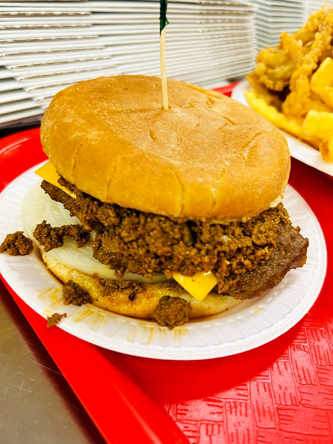This isn't just a cheeseburger—it's a chili-topped monument to excess that requires both hands, several napkins, and absolutely zero regrets.