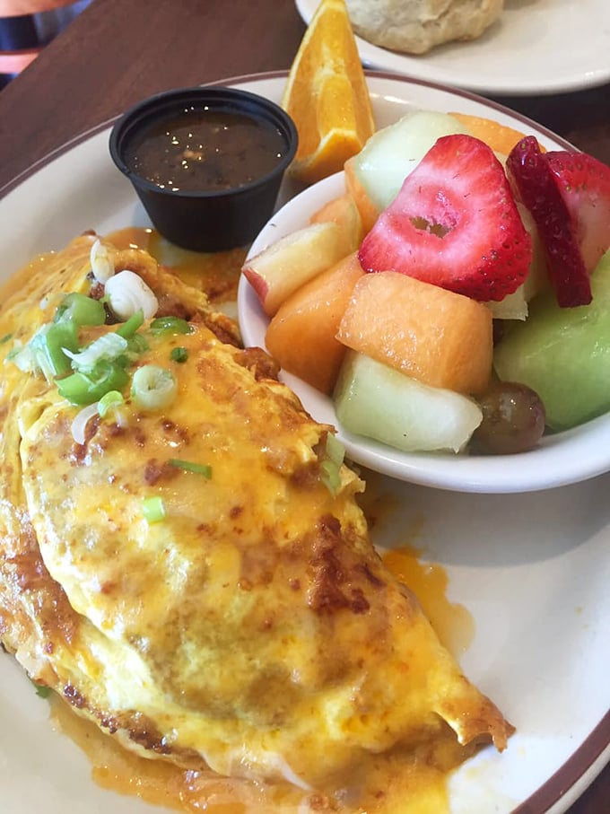Behold the star of our show – a chorizo omelet that's achieved neighborhood legend status. That side of fresh fruit isn't just garnish, it's redemption.