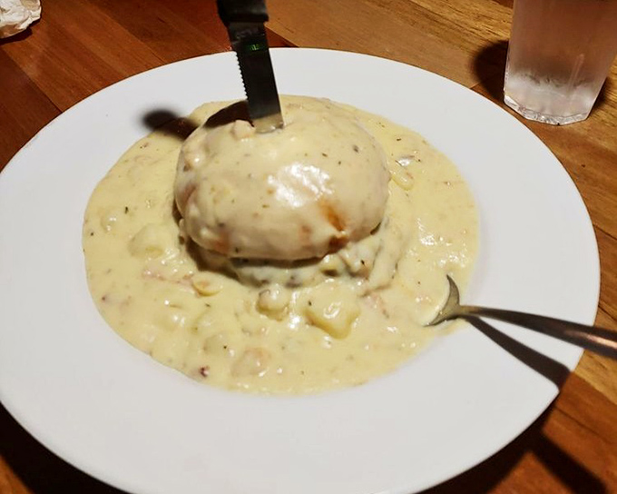 This isn't just chowder—it's a chowder island rising from a creamy sea. The knife stands like a flag claiming territory for your taste buds.