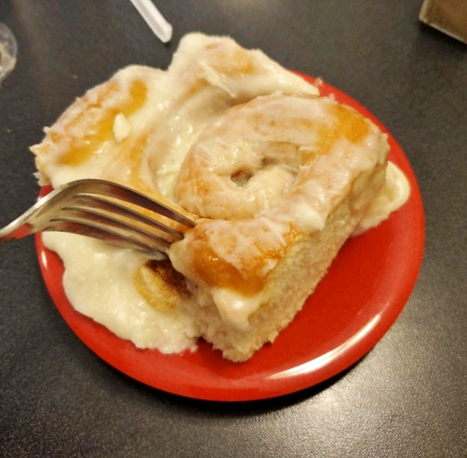 Behold the cinnamon roll in its natural habitat! Cream cheese frosting cascades down warm, spiraled dough like a sweet alpine waterfall.