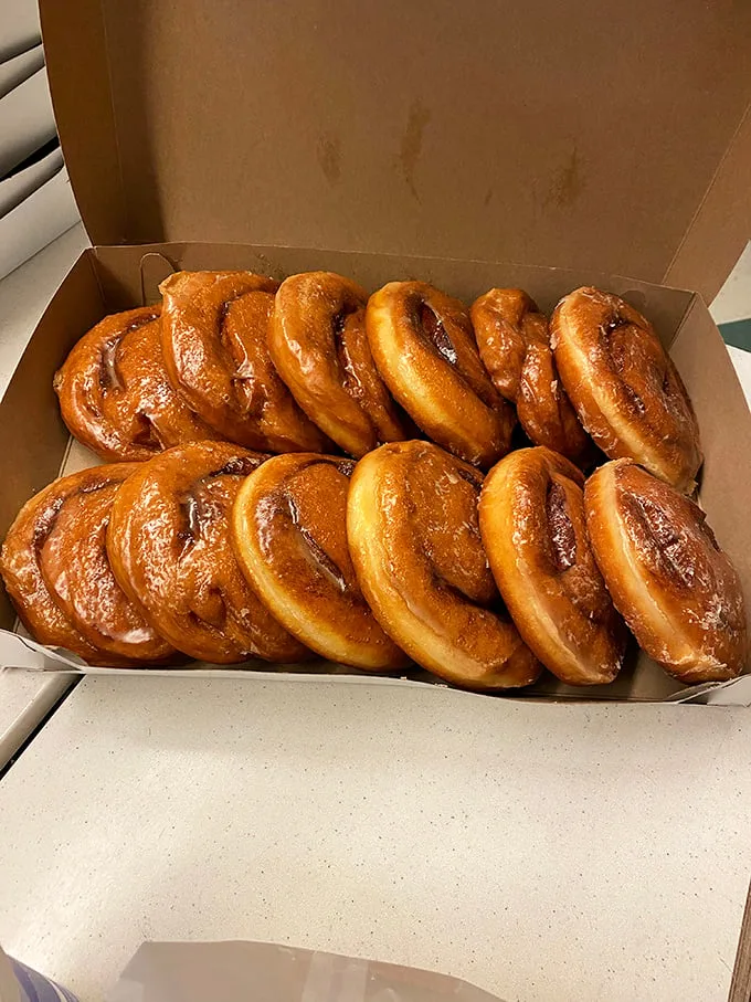 These glazed beauties aren't just donuts—they're edible gold medals, lined up in their box like Olympic champions of the breakfast world.