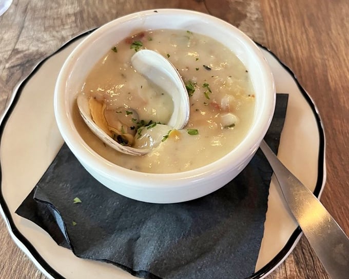 The legendary clam chowder arrives with an actual clam shell – nature's way of saying "this is the real deal, folks."