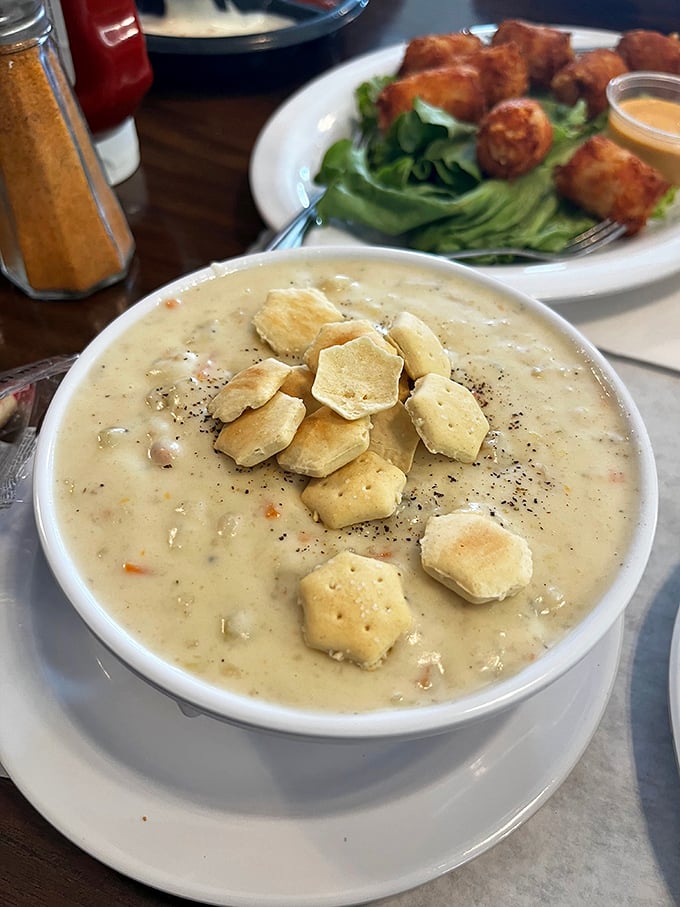 Creamy clam chowder topped with oyster crackers—the kind that makes you close your eyes and forget your table manners.