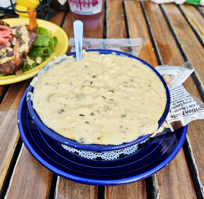The legendary clam chowder arrives in its blue-rimmed glory—creamy, chunky, and worth every mile of your journey.