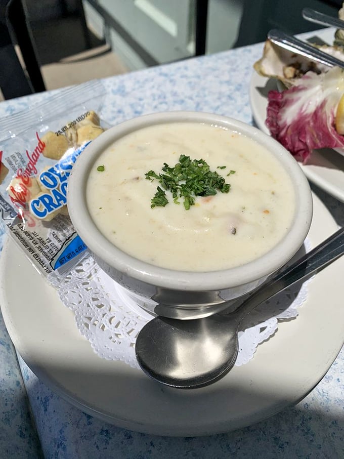 The legendary clam chowder arrives like a creamy revelation, garnished with fresh herbs and accompanied by oyster crackers—spoon-licking perfection in a bowl.