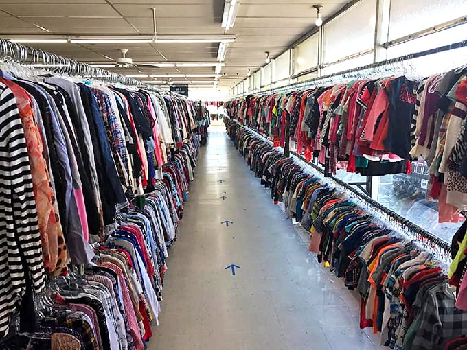 The clothing aisles create a canyon of color and possibility. Walking these pathways feels like traveling through a textile time machine.