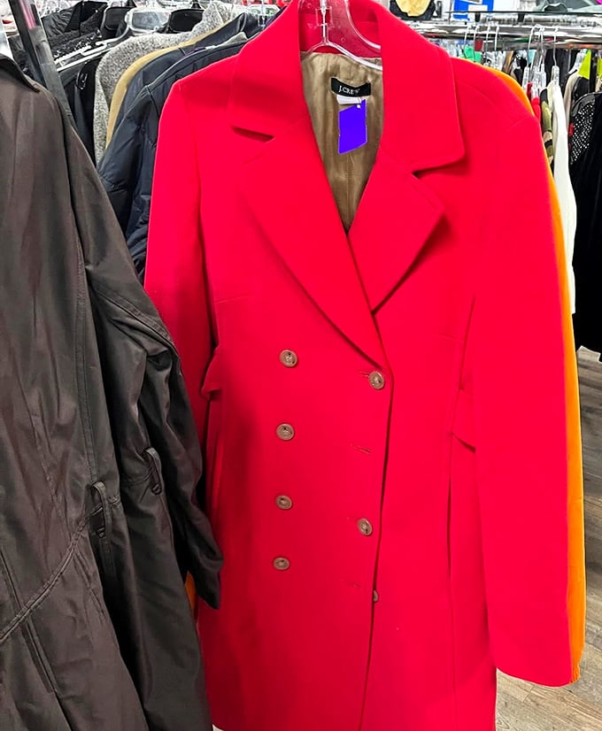 That eye-catching red coat isn't just making a statement—it's delivering a full-blown fashion TED talk among its more subdued neighbors.