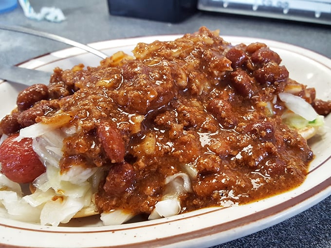 This isn't just a Coney Island – it's a masterclass in comfort food architecture. Chili cascading over a hot dog with the confidence of a Broadway star.