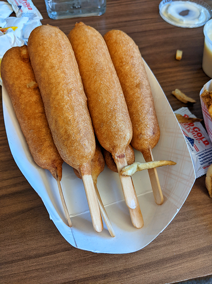 Golden-brown perfection on a stick! These Cozy Dogs aren't just corn dogs—they're edible monuments to American road trip culture.