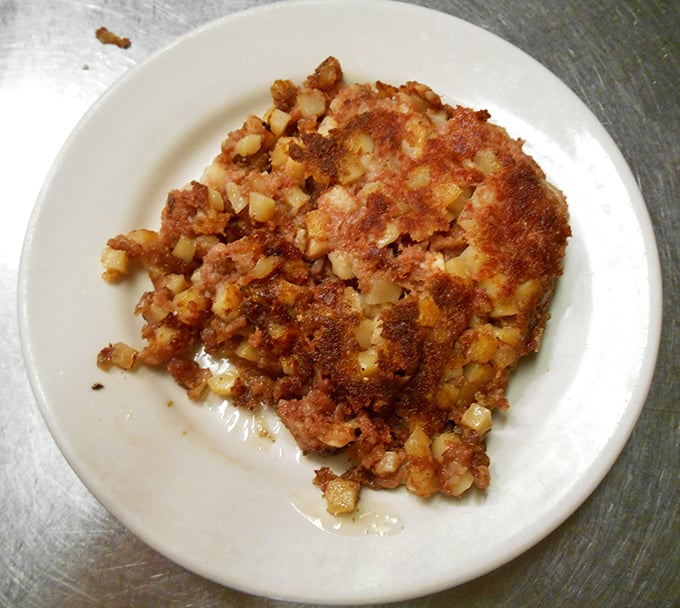 Behold the star attraction—corned beef hash with the perfect crisp-to-tender ratio. This isn't your sad canned variety; this is breakfast elevated to art form.