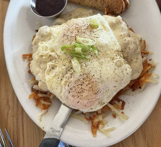 The legendary country fried steak arrives like a work of art – crispy exterior, tender meat, and gravy that could make a vegetarian reconsider life choices.