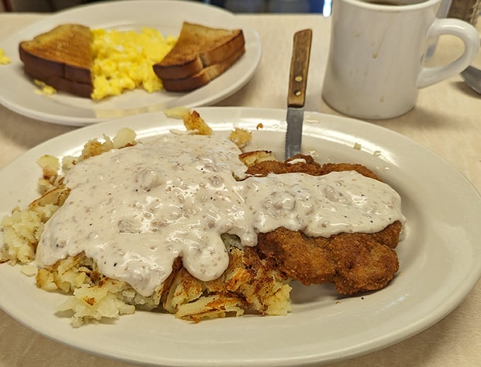 Country fried steak smothered in peppery gravy—a dish so comforting it should come with its own lullaby and tiny blanket.