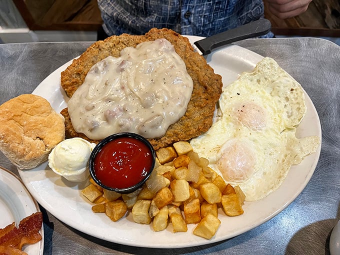 Country fried steak arrives wearing a gravy coat that would make a biscuit jealous – pure Southern comfort engineering.
