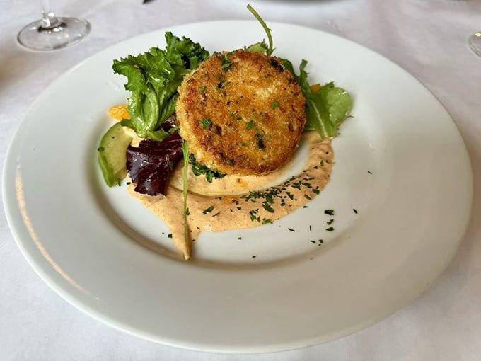 This crab cake doesn't play games with fillers—it's all about the sweet Dungeness meat, crispy exterior, and that silky remoulade underneath.