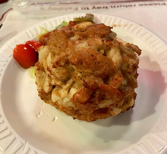Behold the holy grail of crab cakes—softball-sized, golden-brown, and packed with sweet jumbo lump meat. This isn't food; it's edible Maryland heritage.