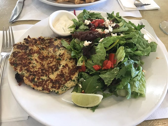 The star of the show: a golden-brown crab cake that's almost entirely seafood, not filler—paired with greens that aren't just an afterthought.