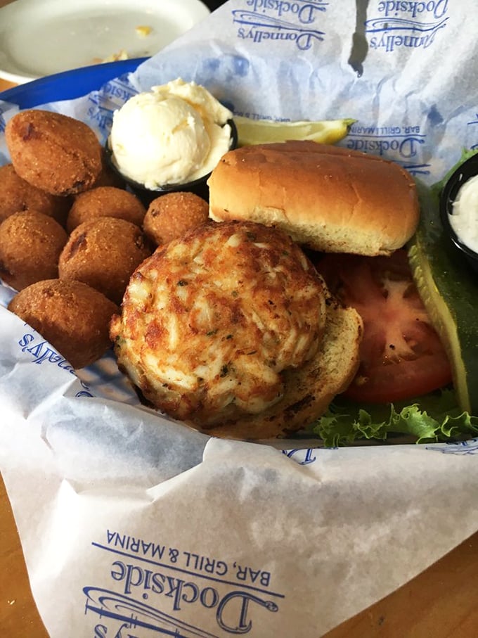 This isn't just a crab cake sandwich—it's Maryland's soul on a bun, accompanied by hushpuppies that could make a Southern grandma jealous.
