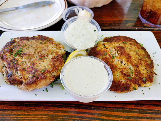These golden-brown beauties aren't just crab cakes – they're edible proof that sometimes the simplest pleasures are the most profound.
