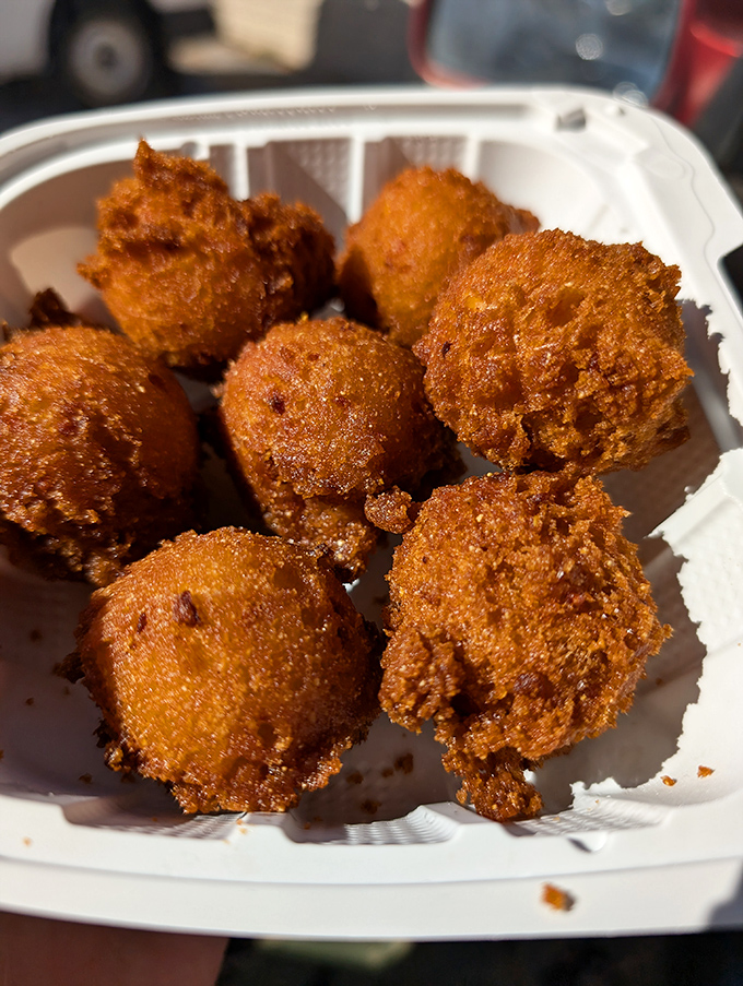 Golden-brown perfection! These hush puppies aren't just fried dough—they're little orbs of cornmeal joy waiting to complement your seafood feast.