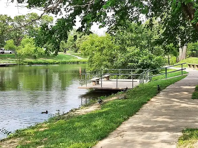 Nature's therapy session awaits at this serene park pond, where ducks hold daily meetings and humans come to forget about spreadsheets.