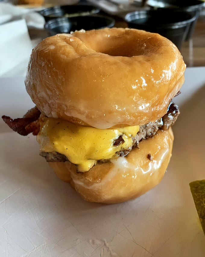 Behold the donut burger—where breakfast and lunch collide in a sweet-savory explosion that makes you wonder why more foods aren't served between glazed donuts.