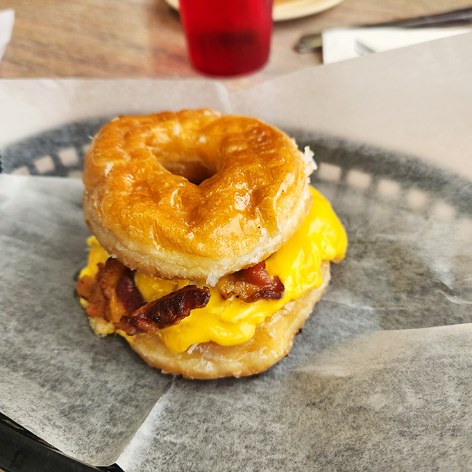 Breakfast architecture at its finest! A glazed donut embracing eggs, bacon and cheese—proof that sometimes the best ideas happen outside the toast box.