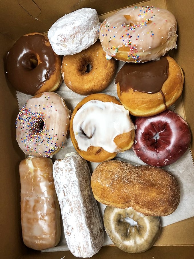 A box of donuts so perfect they could make Homer Simpson weep tears of joy. That powdered sugar one is calling my name.