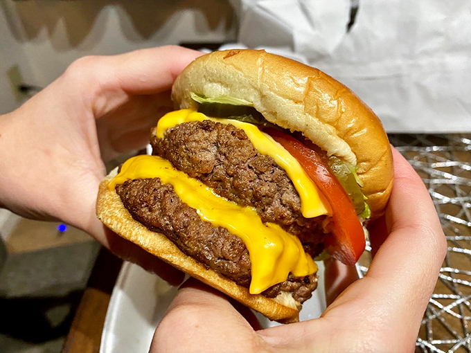 Two perfectly seared patties, melted cheese cascading down the sides—this Double Zip Burger isn't trying to be Instagram-famous; it's too busy being delicious.