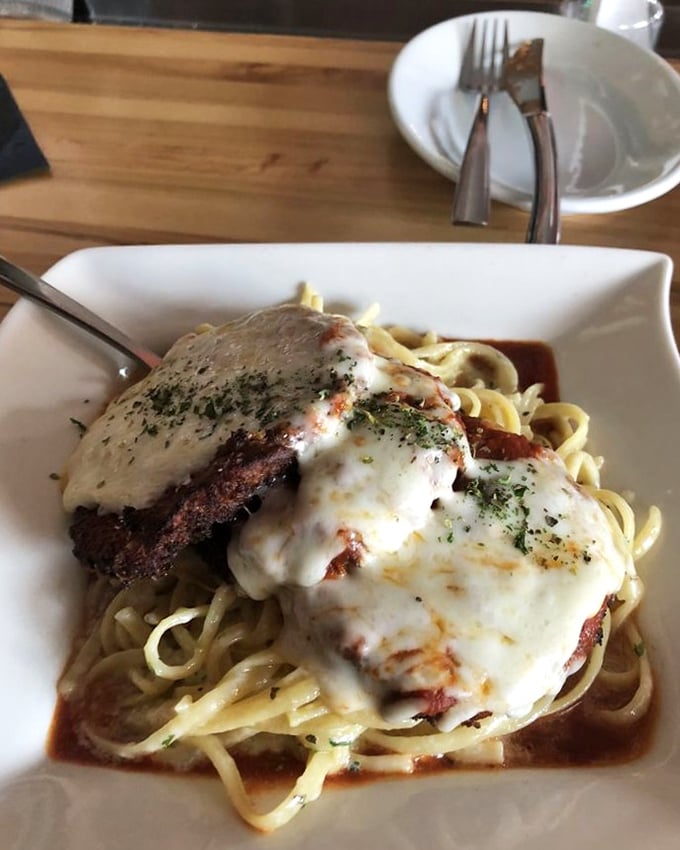 This isn't your nonna's eggplant parm—it's a melty masterpiece of crispy-meets-creamy, perched atop pasta like it owns the place.