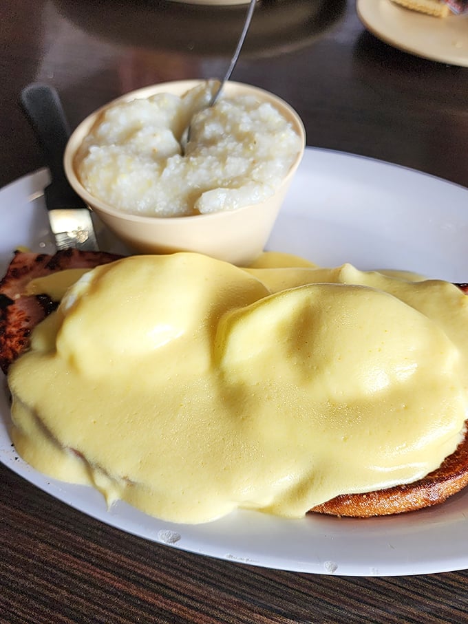 Hollandaise sauce cascading over perfectly poached eggs like a golden waterfall. This Benedict might just be worth crossing state lines for.