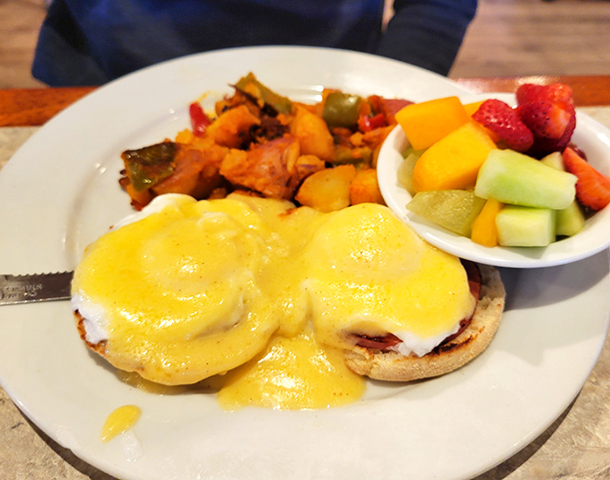 Behold the star attraction: eggs Benedict with perfectly poached eggs draped in sunshine-yellow hollandaise, served with colorful fruit that almost steals the spotlight. Almost.