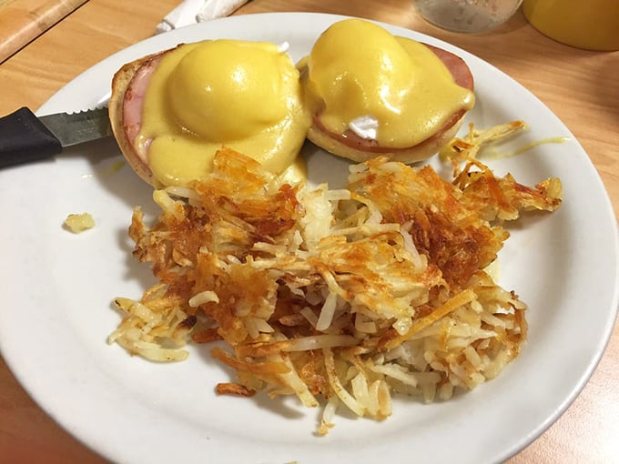Eggs Benedict doing what it does best: making hollandaise the star while hash browns play the perfect supporting role.