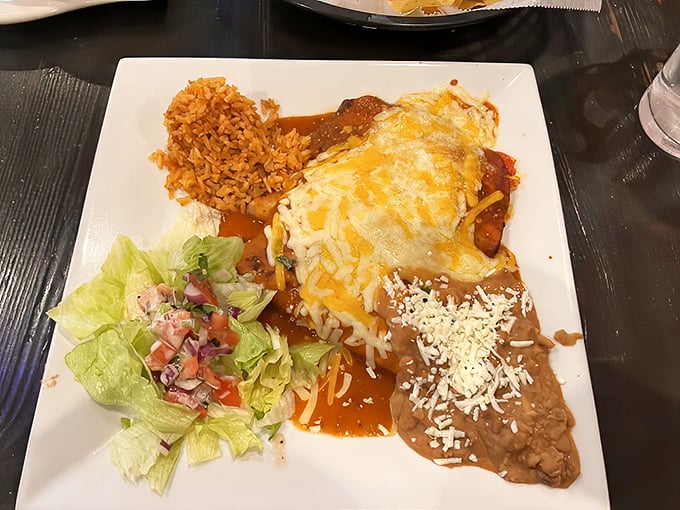 This isn't just an enchilada—it's a masterclass in sauce-to-cheese ratio, with rice that actually deserves its place on the plate.