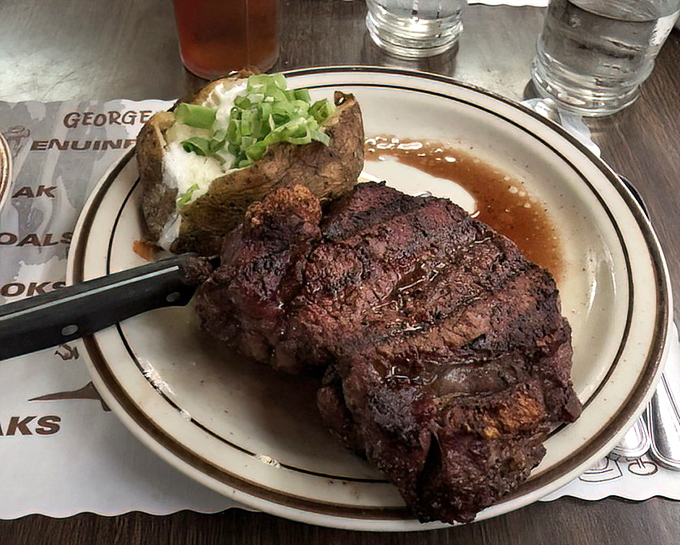 This isn't just a steak; it's a masterclass in oak-fired perfection. The baked potato stands by like a loyal sidekick, ready to soak up any stray juices.
