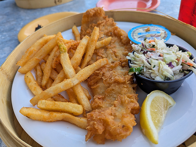 Behold the golden glory that launched a thousand return visits – crispy perfection meets flaky fish heaven.