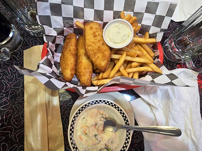 Golden-battered fish and crispy fries served in a checkered basket – proof that sometimes the simplest pleasures are the ones worth driving across state lines for.