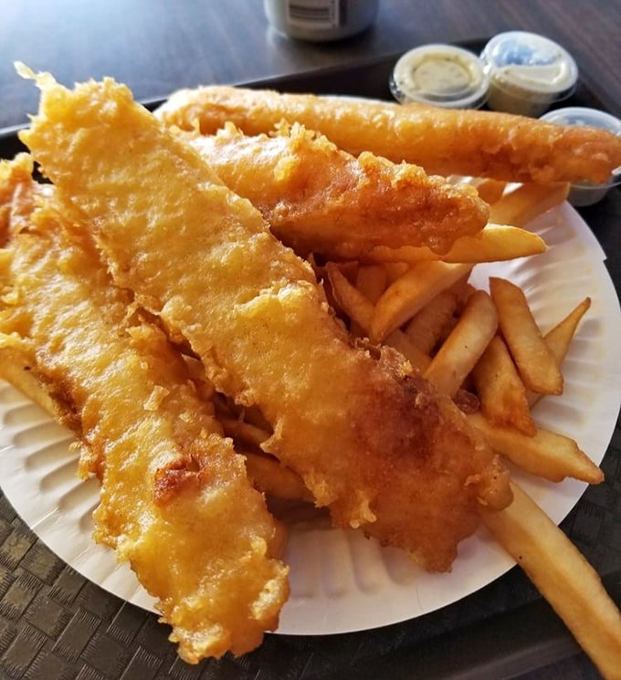 Golden armor protecting tender white fish flanked by crispy soldiers of potato. This plate isn't just food – it's edible sunshine.
