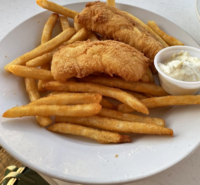 Golden-battered fish that shatters with each bite, alongside fries that deserve their own fan club. This isn't just fish and chips—it's edible sunshine.