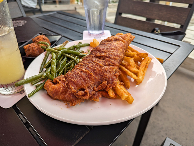 The fish and chips that launched a thousand return visits. That golden-brown crust shatters perfectly, revealing flaky white fish beneath.