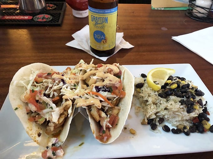 These fish tacos aren't just a meal—they're a beach vacation wrapped in a tortilla. The black bean and corn rice side dish is no mere afterthought.