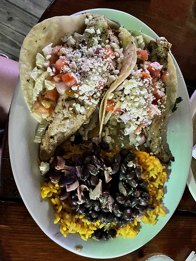 These fish tacos aren't just a meal, they're a vacation on a plate—seasoned fish, fresh pico, and that perfect rice-and-beans foundation that makes everything better.