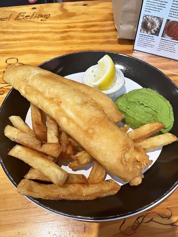 Golden-battered fish that shatters like glass, chips with the perfect crisp-to-fluffy ratio, and that vibrant mushy peas—Britain's finest export.