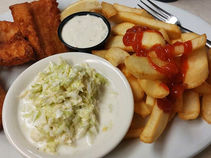 Golden-fried fish fillets that crackle with each bite, paired with crispy fries and creamy coleslaw—a trio that never disappoints.