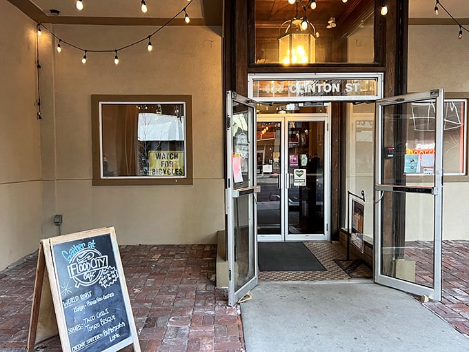The entrance to Flood City Café beckons with the promise of caffeine and community. String lights and brick walkways—the universal language of "come in, stay awhile."